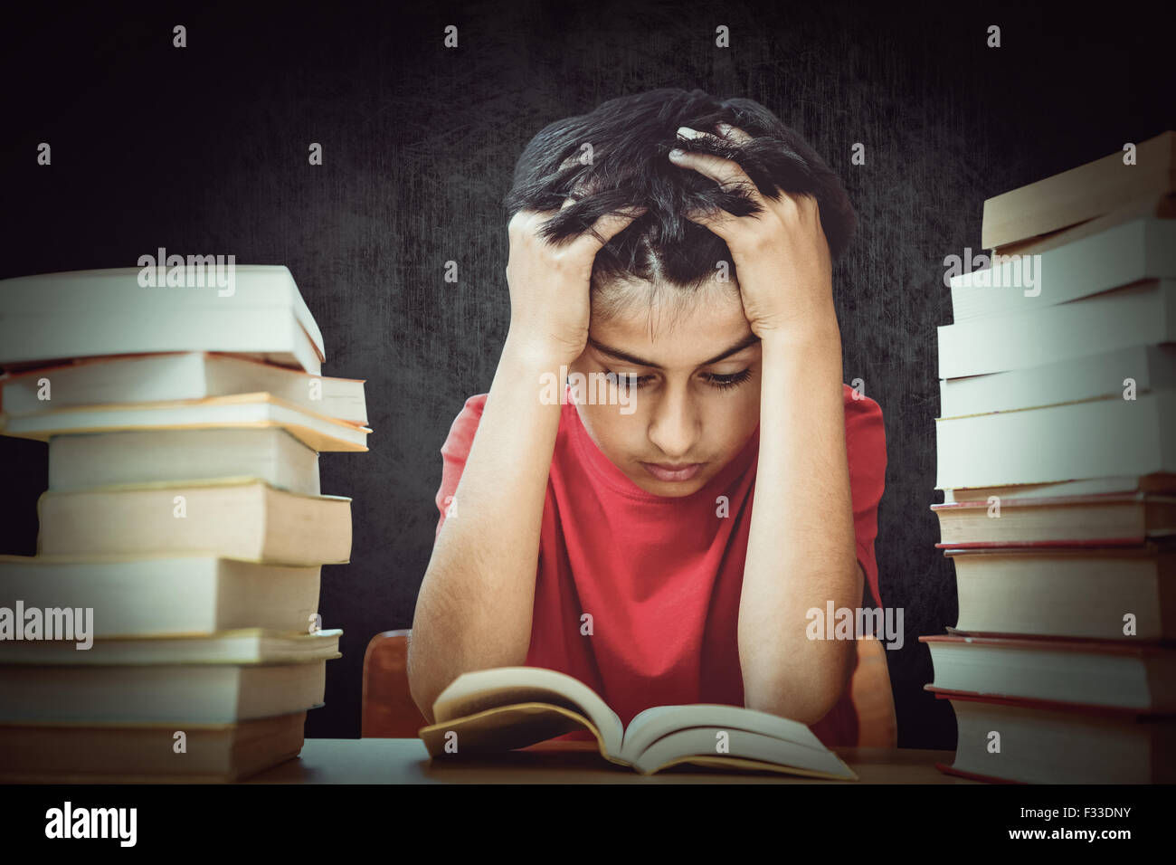 Composite image of tensed boy sitting with stack of books Stock Photo ...