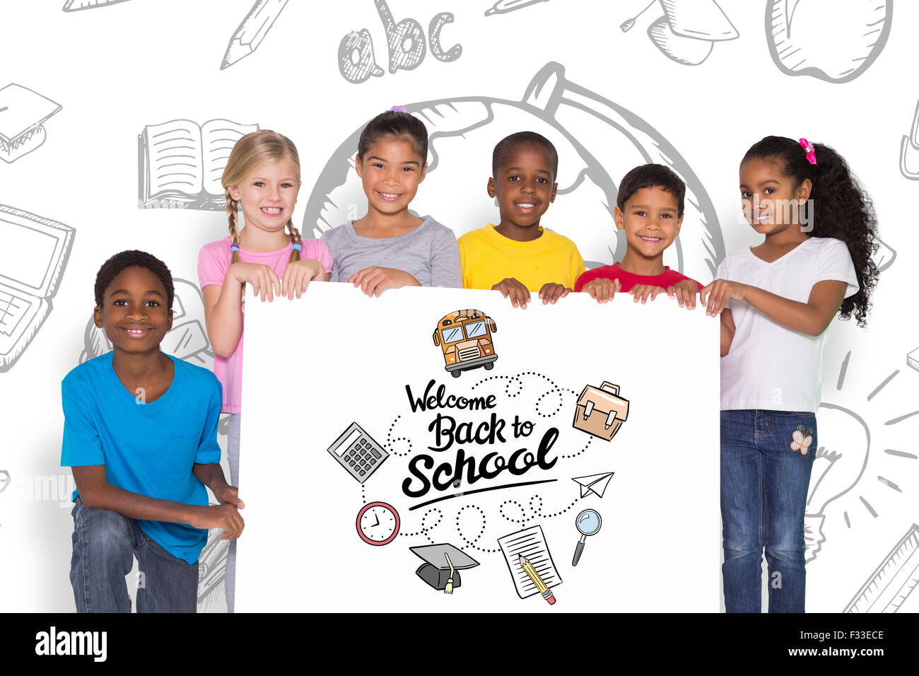 Composite image of elementary pupils showing card Stock Photo - Alamy