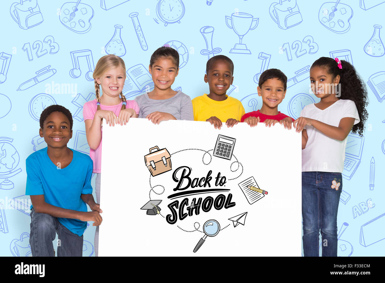 Composite image of elementary pupils showing card Stock Photo - Alamy