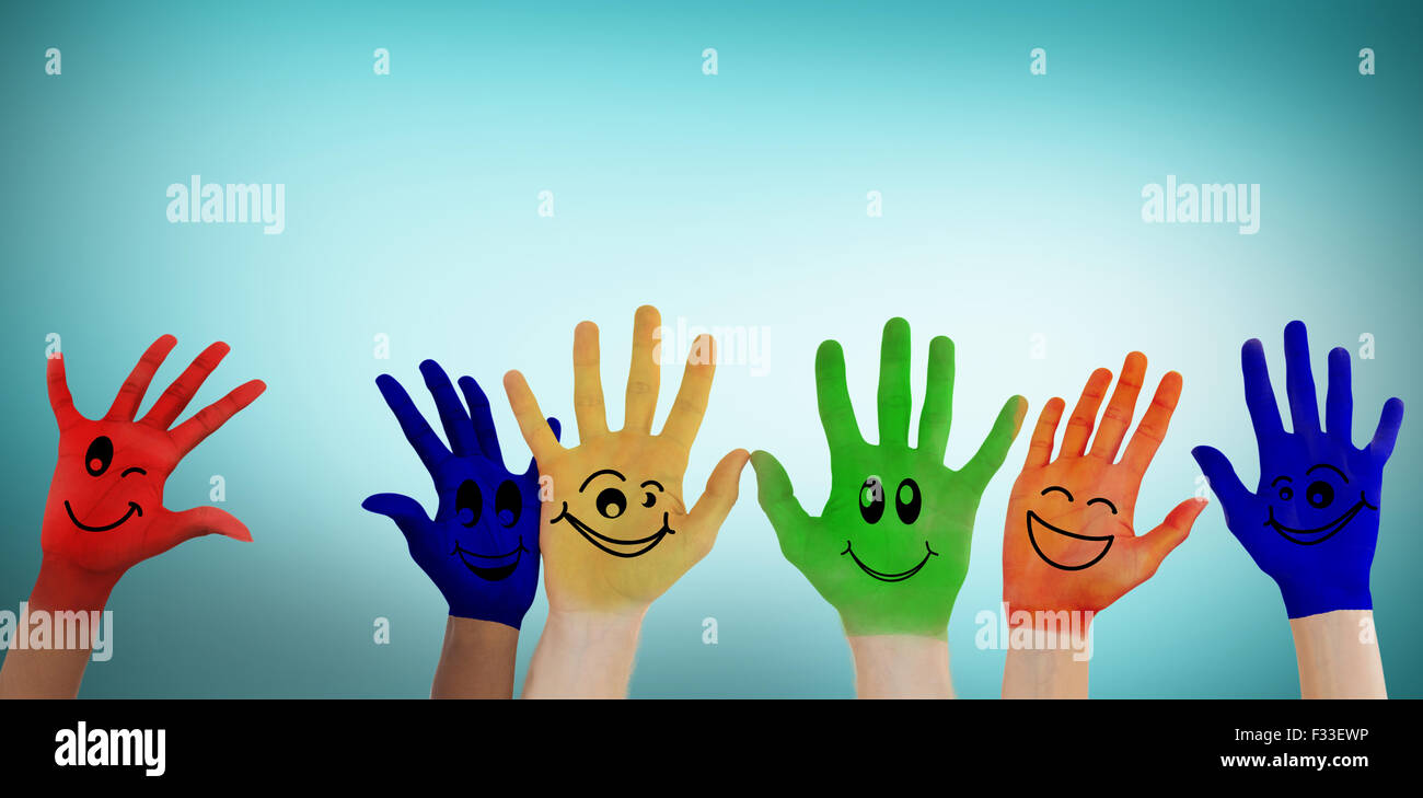 Composite image of hands with colourful smiley faces Stock Photo - Alamy