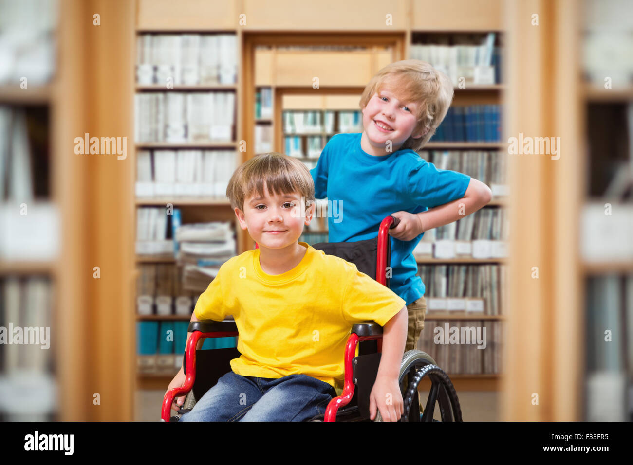 Composite image of happy boy pushing friend on wheelchair Stock Photo ...