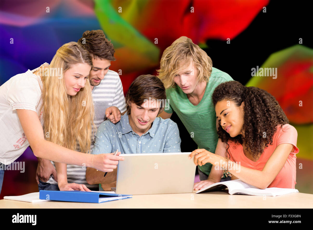 Composite image of college students using laptop in library Stock Photo ...