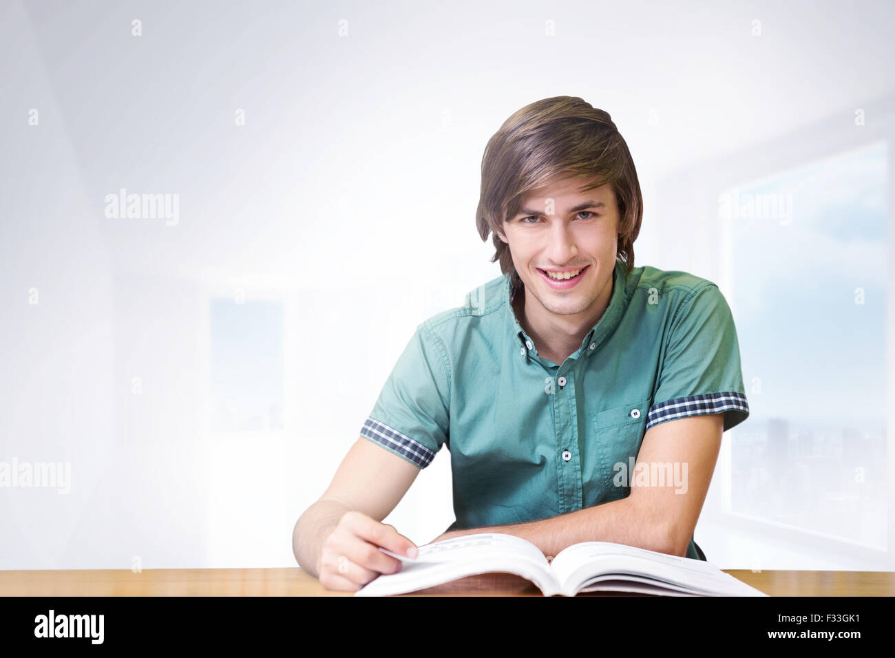 Composite image of student sitting in library reading Stock Photo - Alamy