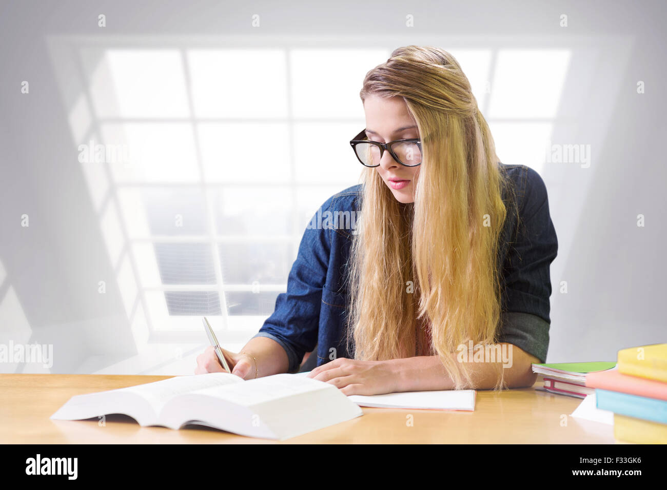 Composite image of student studying in the library Stock Photo - Alamy