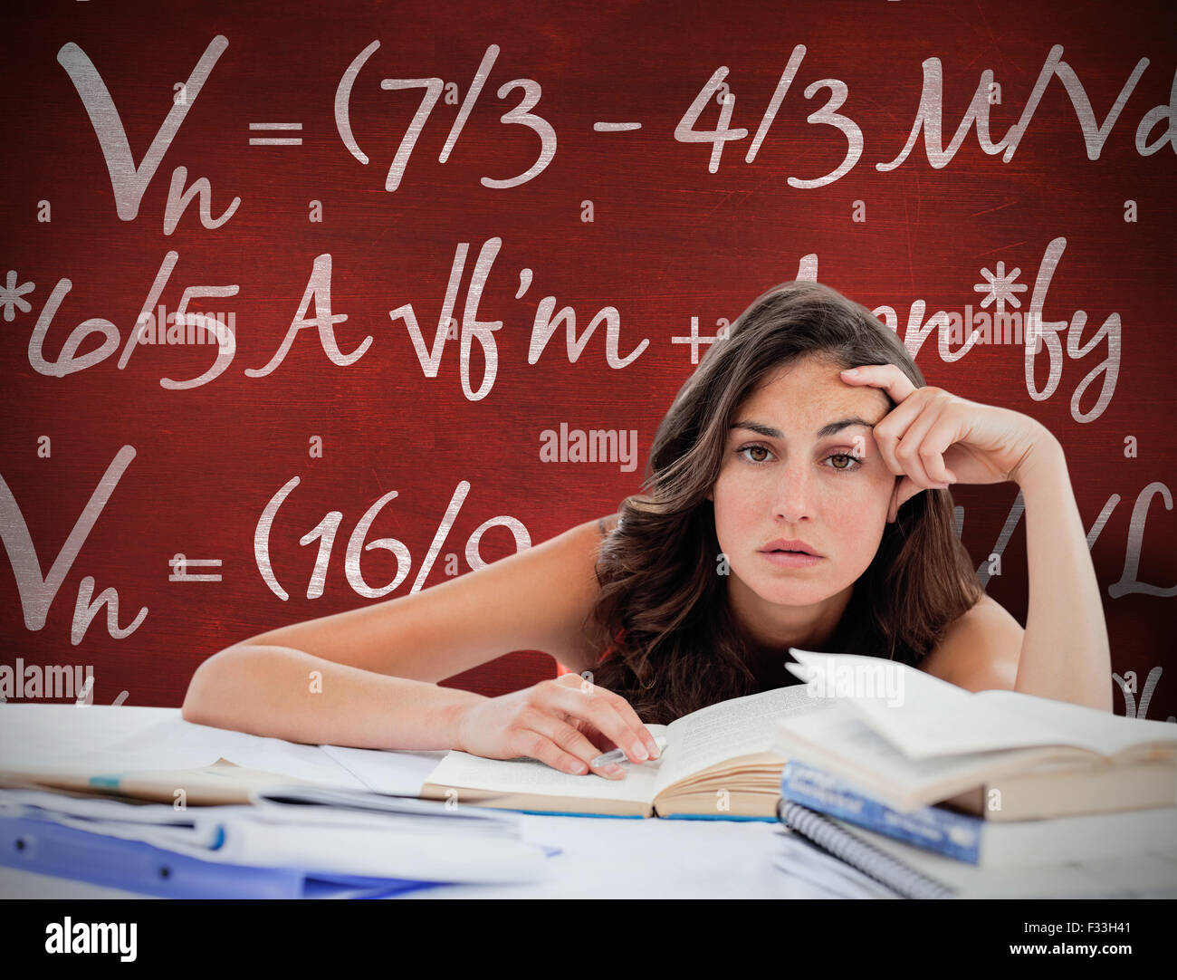 Composite image of bored student doing her homework Stock Photo - Alamy