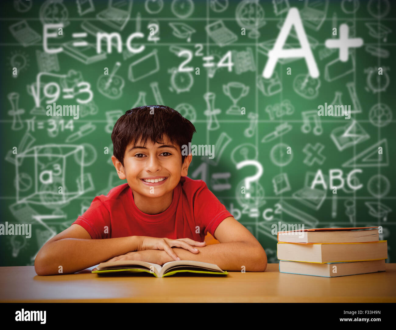 Composite image of cute boy reading book in library Stock Photo - Alamy