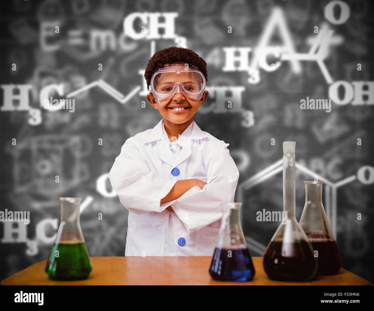 Composite image of cute pupil dressed up as scientist Stock Photo - Alamy