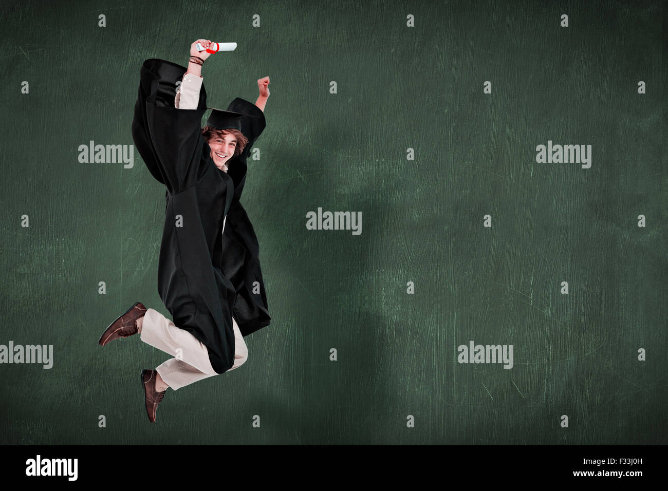 Happy jumping graduate holding diploma hi-res stock photography and ...