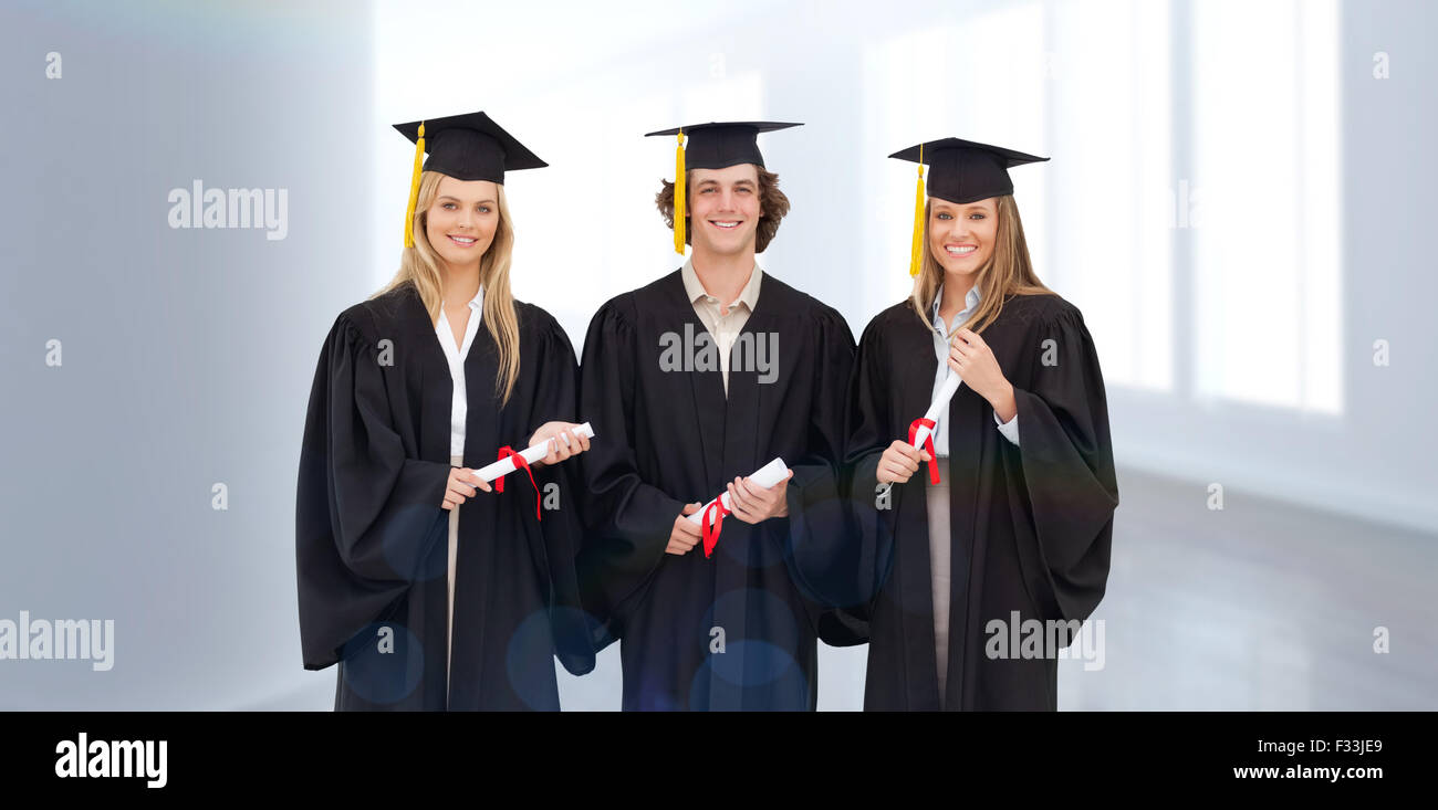 Composite image of three students in graduate robe holding a diploma ...
