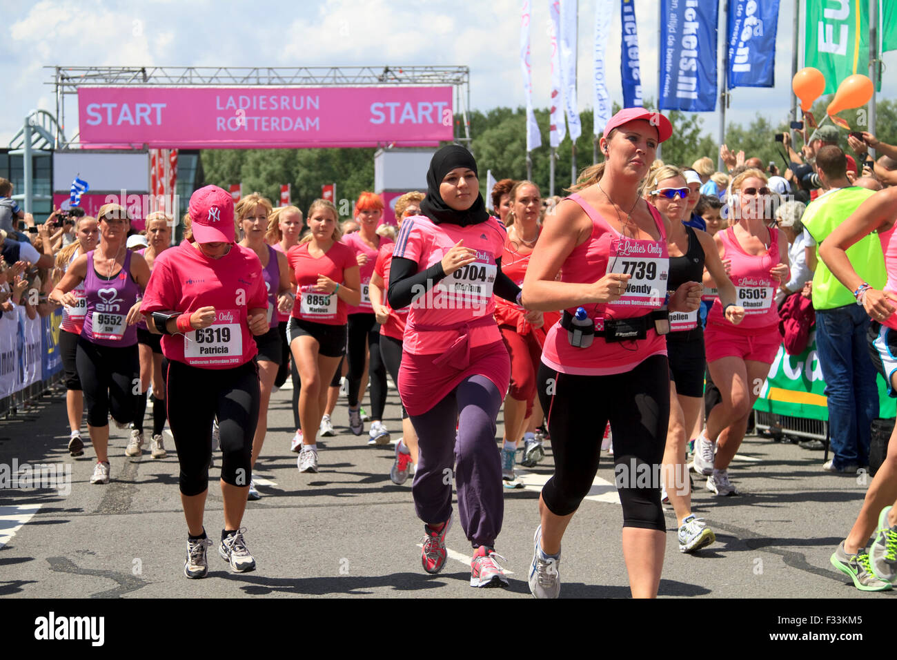 The start of the race with contestants dressed mainly in pink running ...