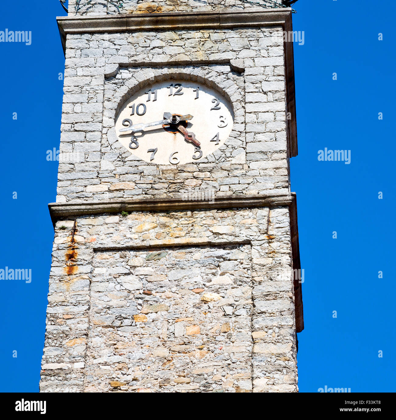 ancien clock tower in italy europe old stone and bell Stock Photo - Alamy