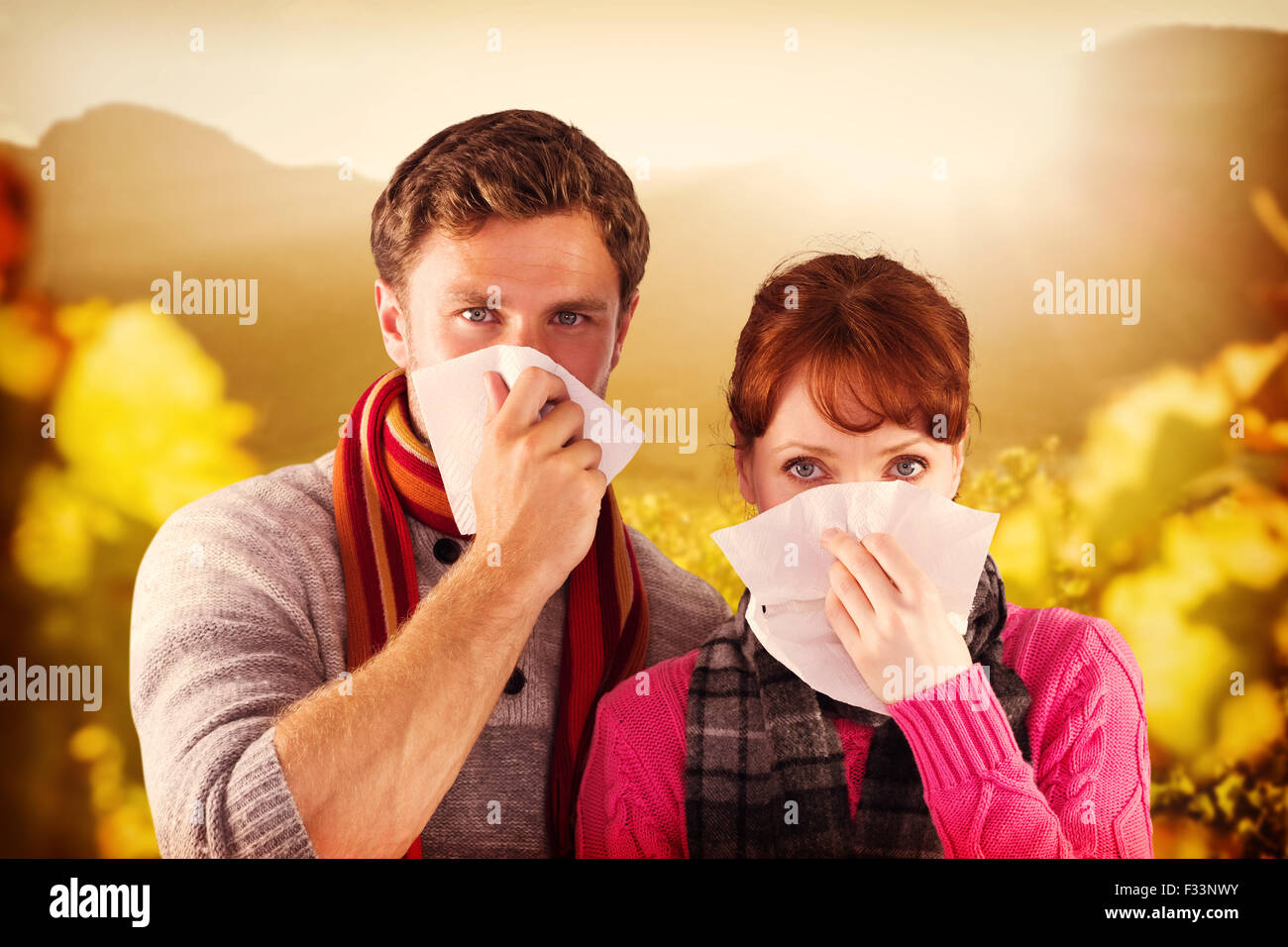 Composite image of couple blowing noses into tissues Stock Photo - Alamy