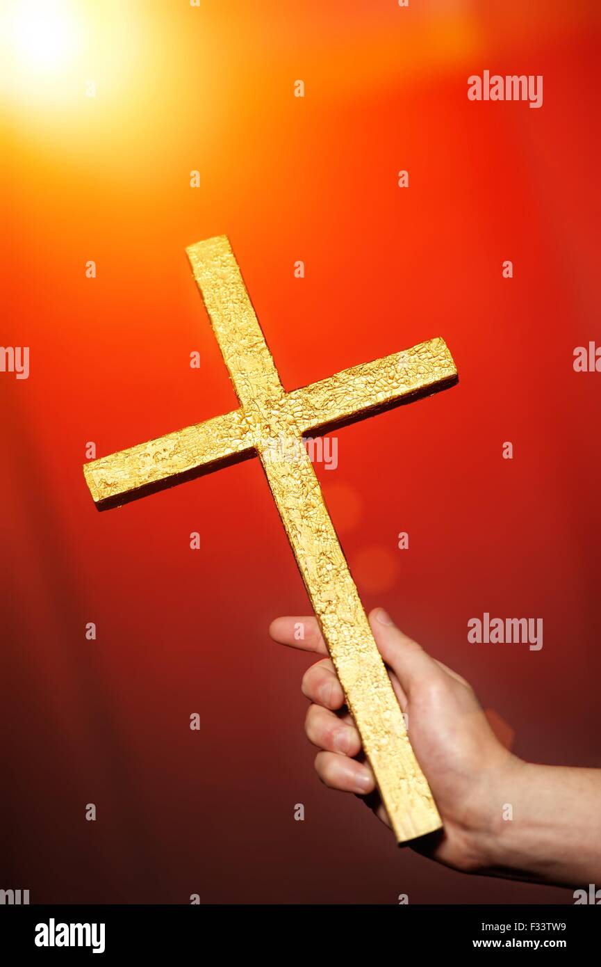 Golden cross in human hand Stock Photo - Alamy