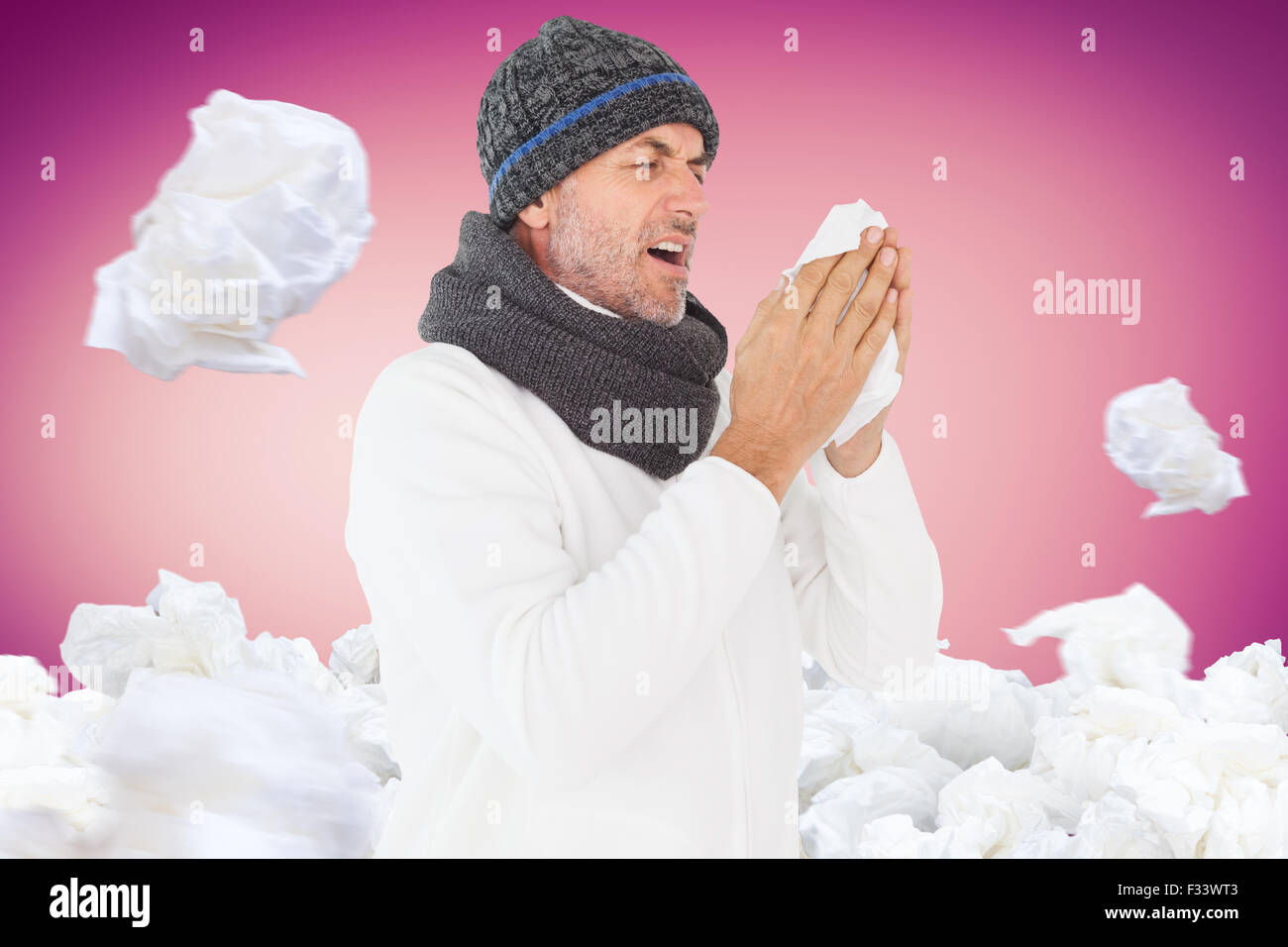 Composite image of sick man in winter fashion sneezing Stock Photo - Alamy