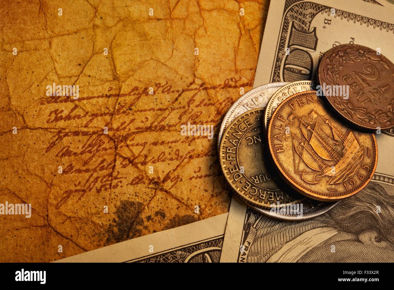 Ancient money on the old textured paper Stock Photo - Alamy