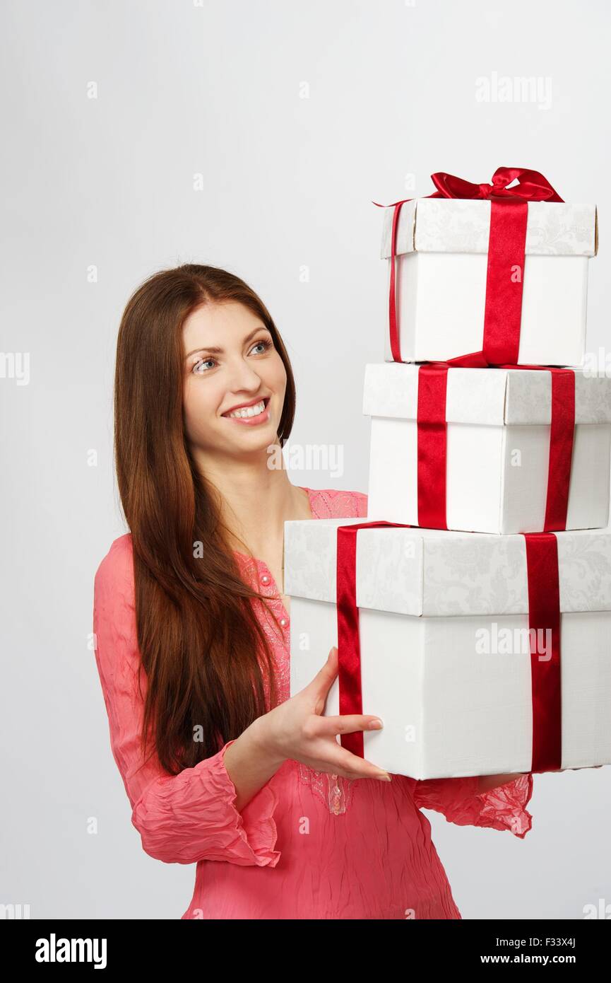 Beautiful brunette woman with a gift boxes Stock Photo - Alamy