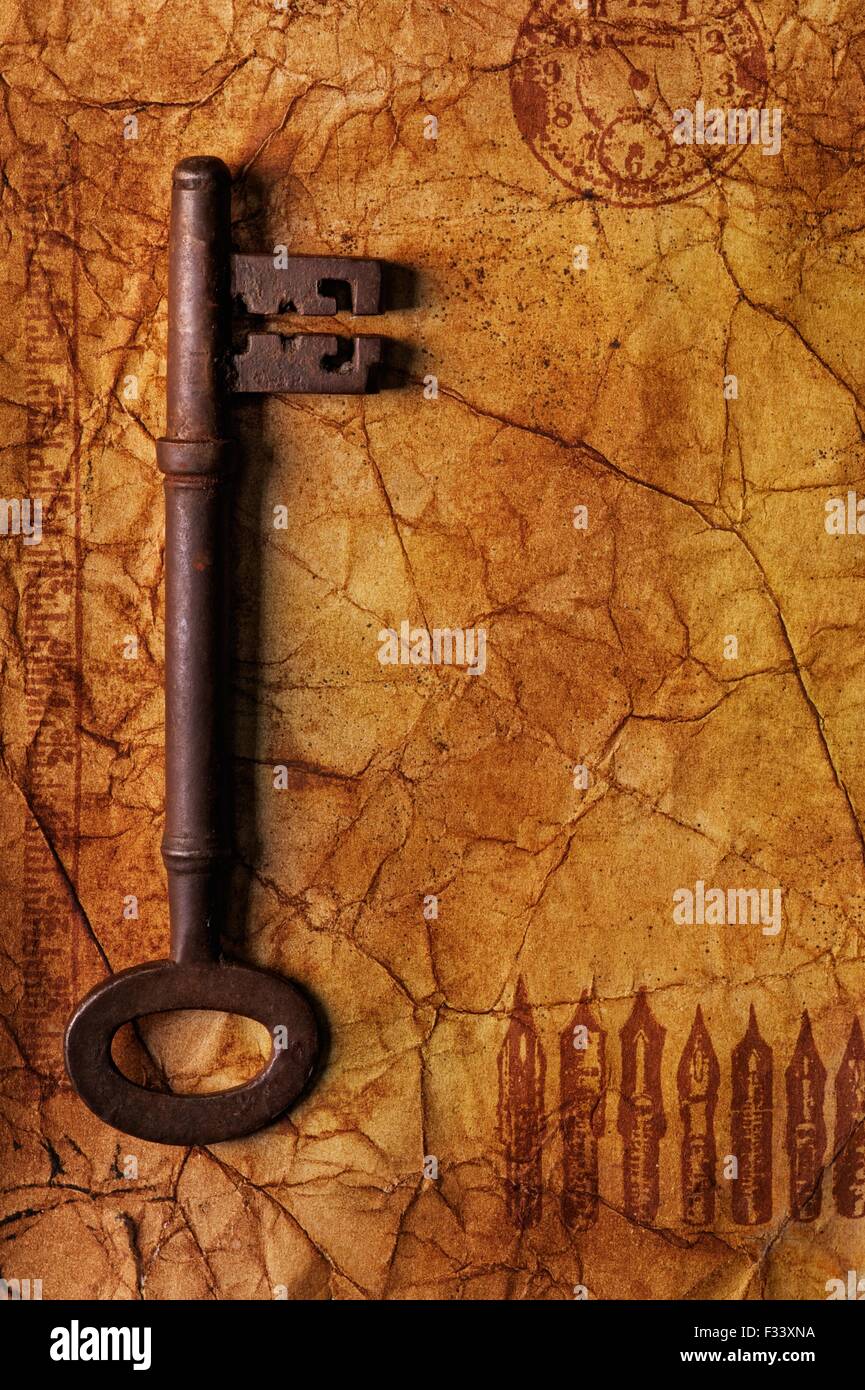 The old key on the textured paper Stock Photo - Alamy