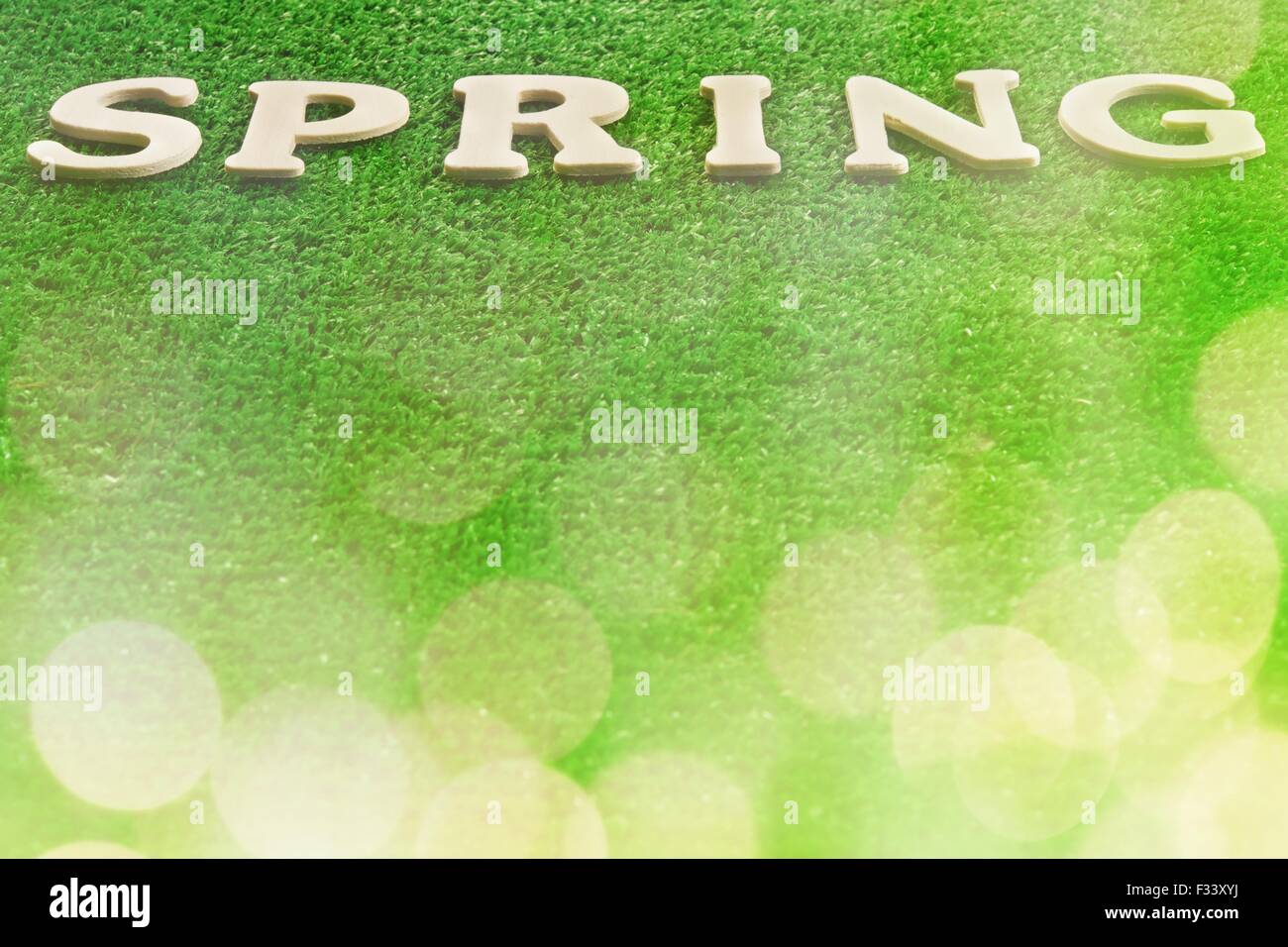 The word spring written on green background Stock Photo - Alamy