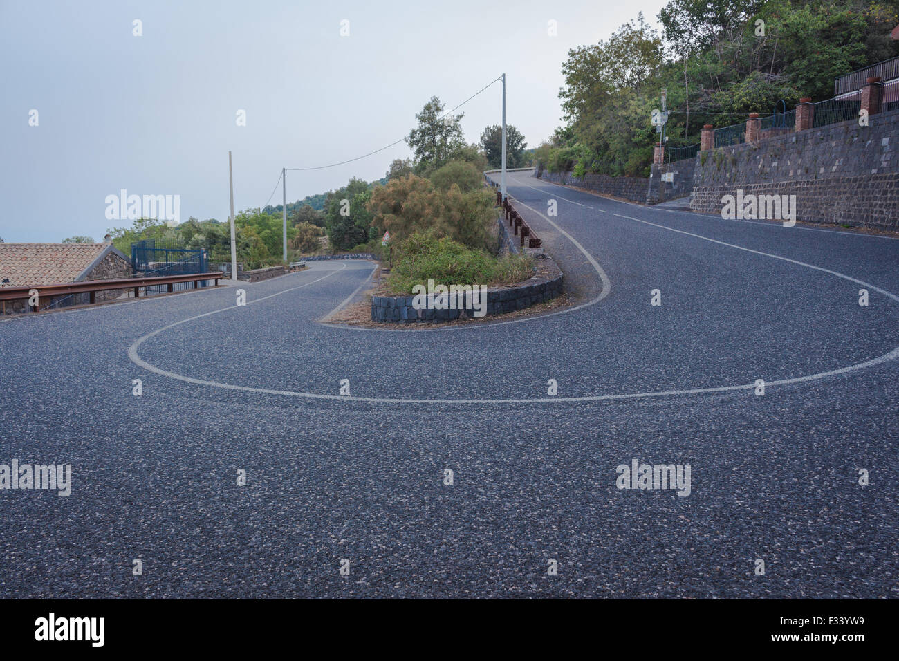 The curve road on a mountain with trees Stock Photo - Alamy