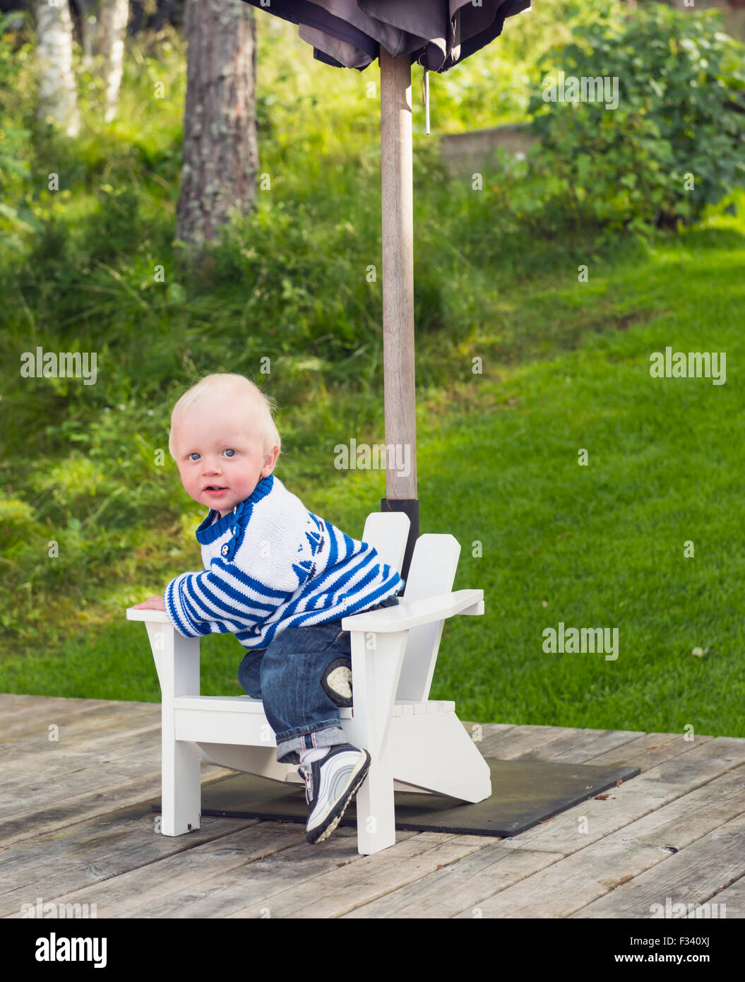 Young boy in small chair Stock Photo - Alamy