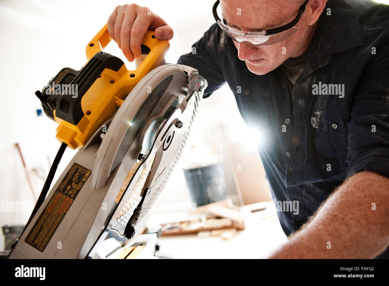 An older male uses a table saw on a job site Stock Photo - Alamy