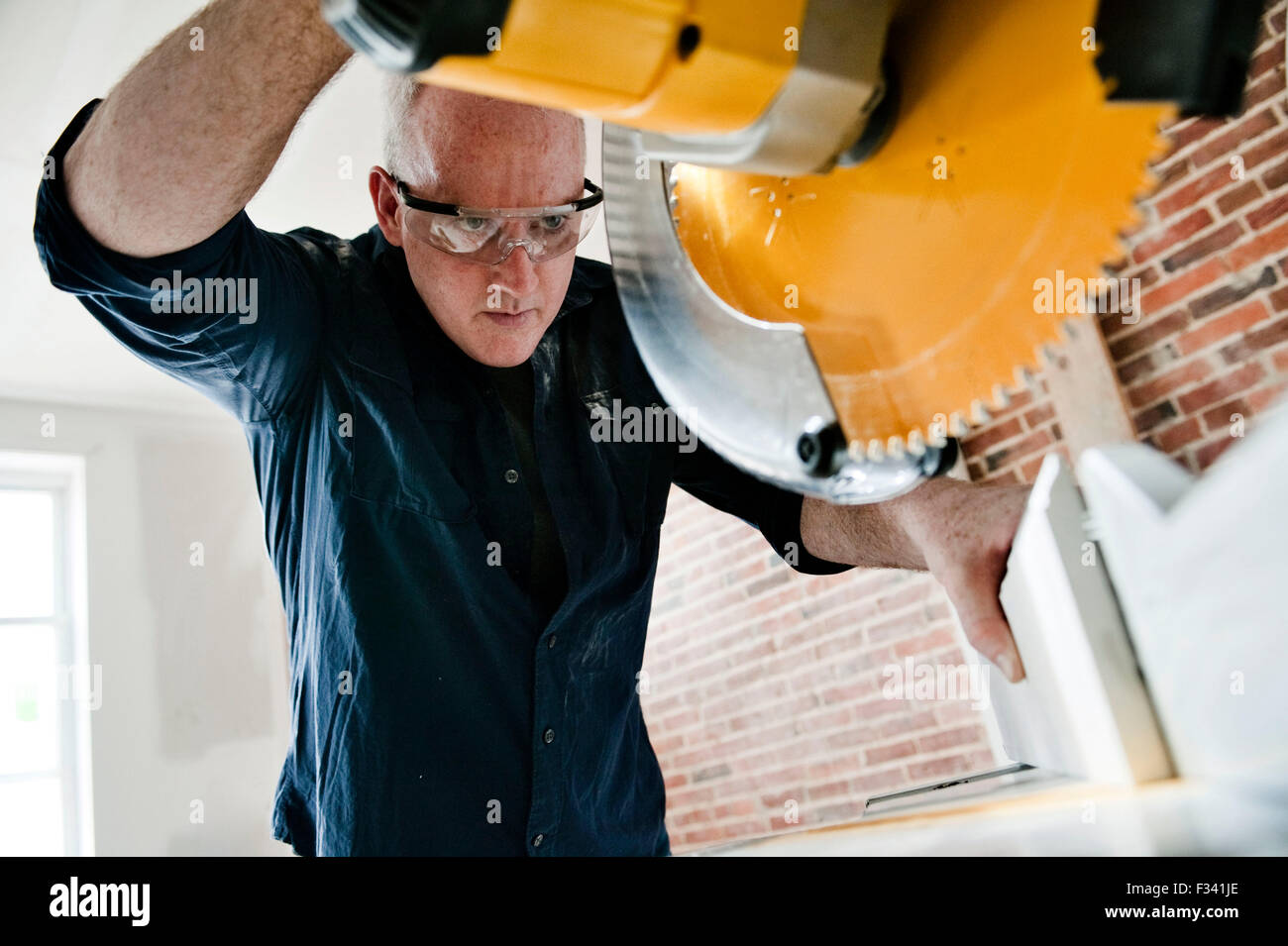 An older male uses a table saw on a job site Stock Photo - Alamy