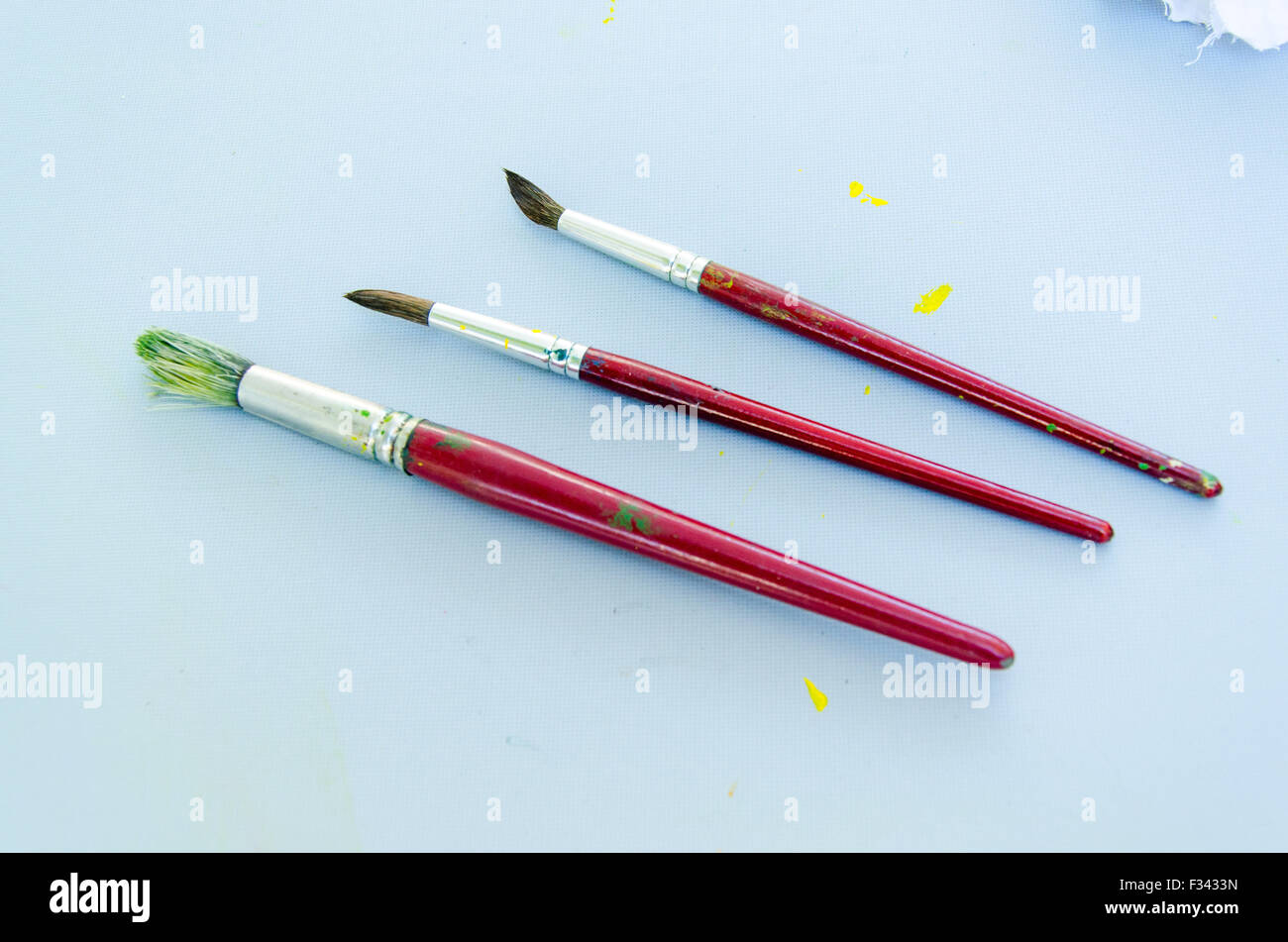 A set of three dirty paintbrushes isolated Stock Photo - Alamy