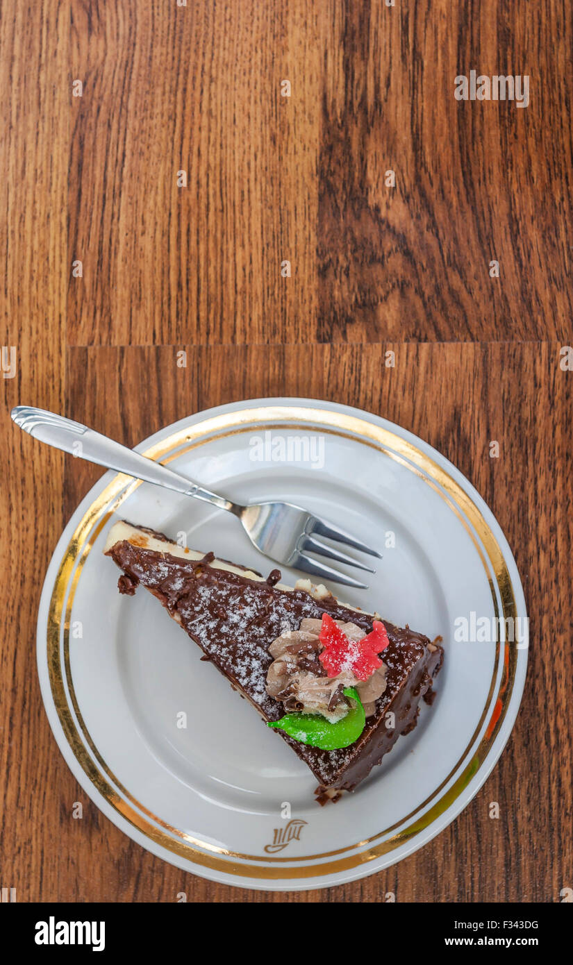 Chocolate Cake And Fork On A Saucer Stock Photo - Alamy