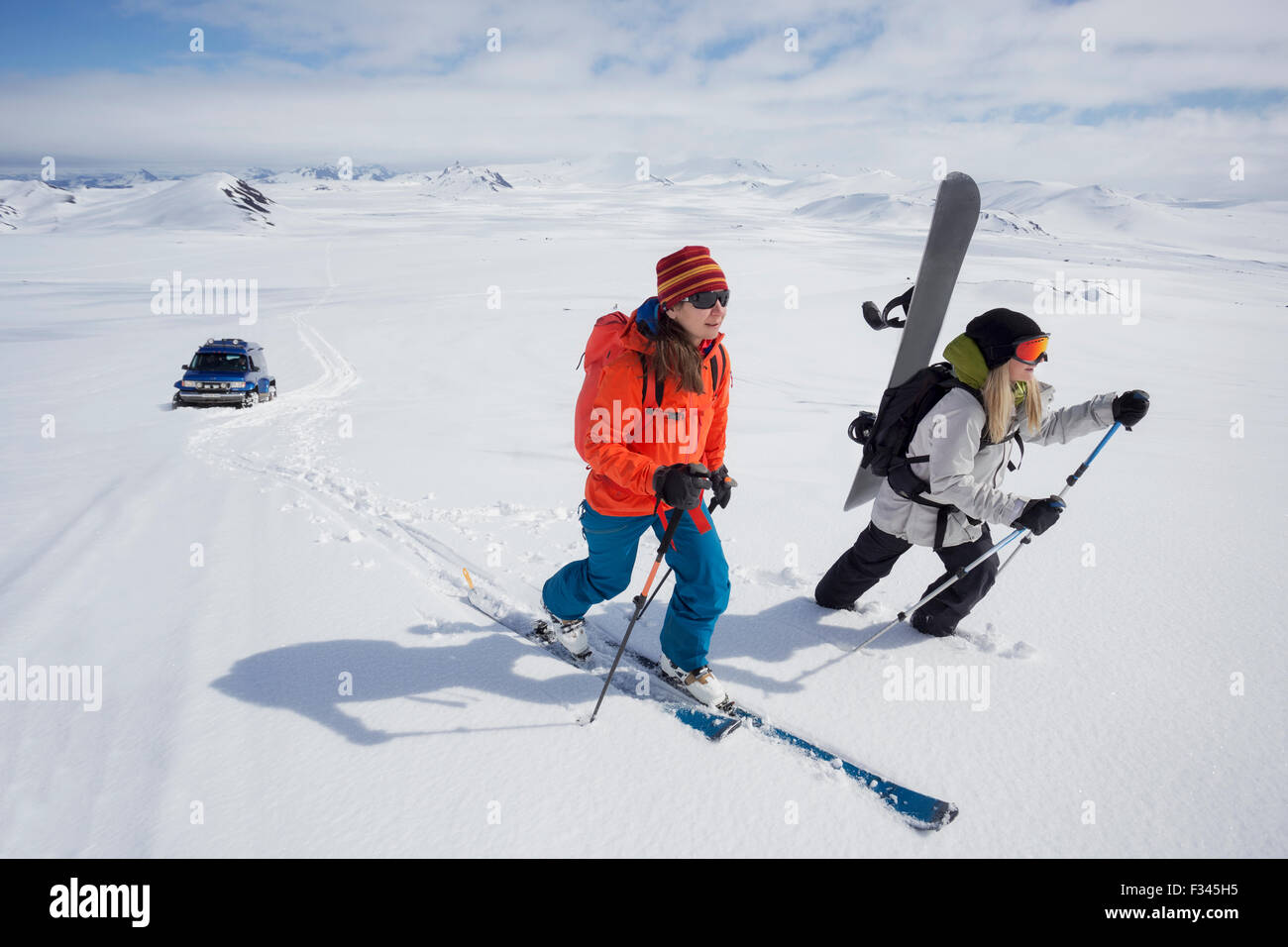 Two girls ski and snowboard touring up Mount Hekla, Iceland Stock Photo ...