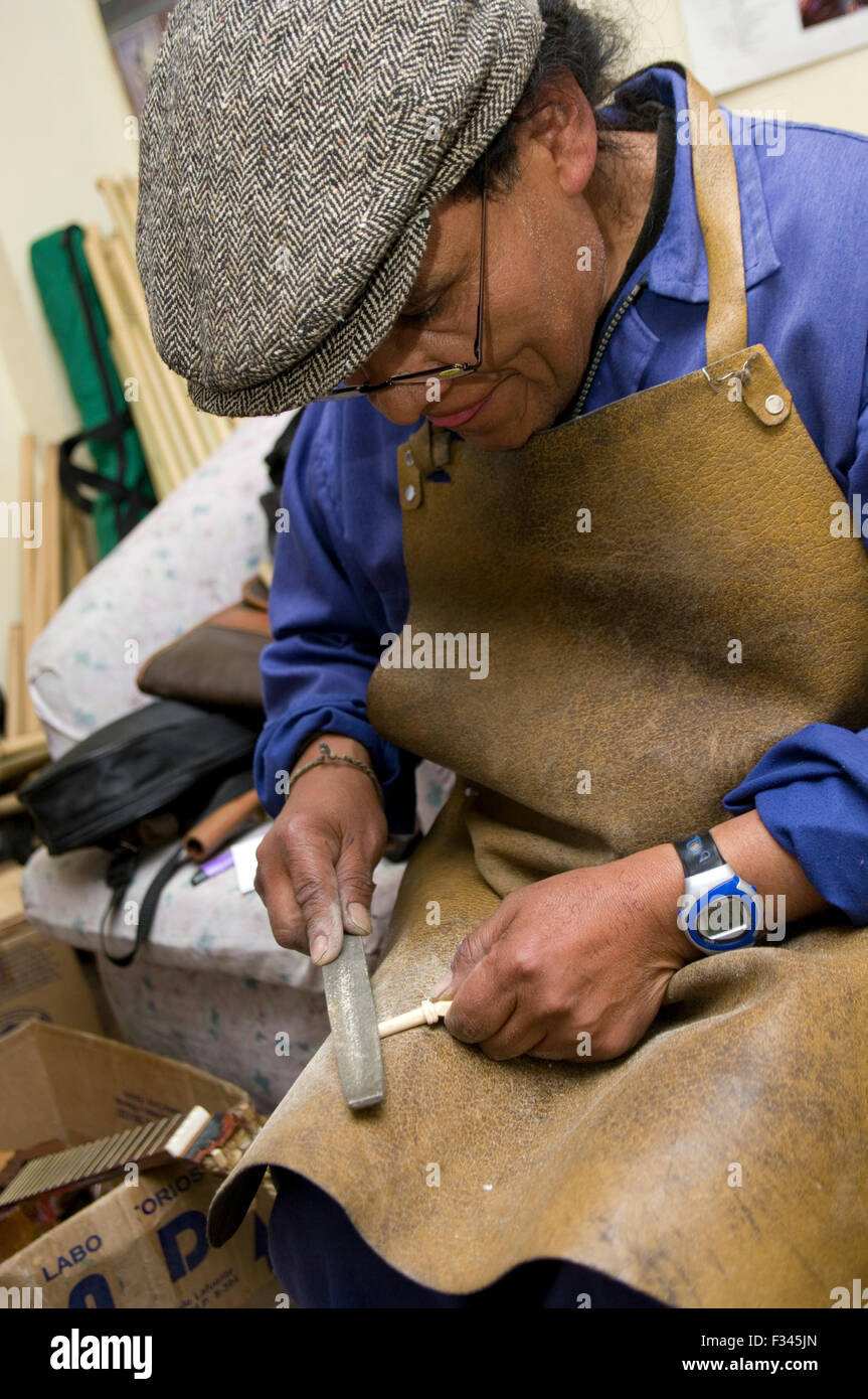 Artisan Adrian Villanueva Quisbert making a charango, a traditional ...