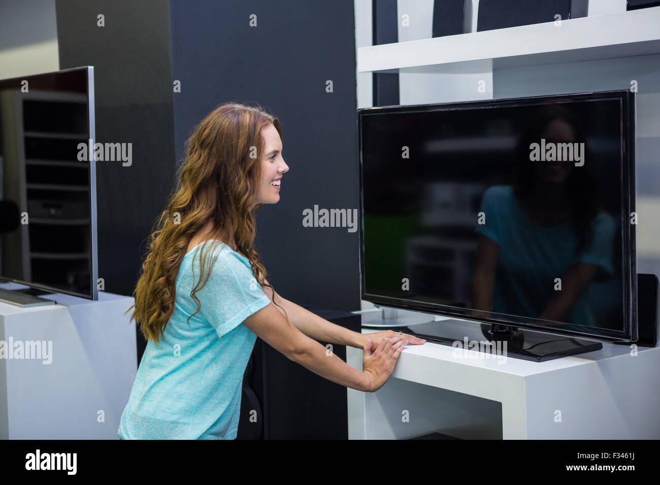 Pretty woman shopping for new television Stock Photo - Alamy