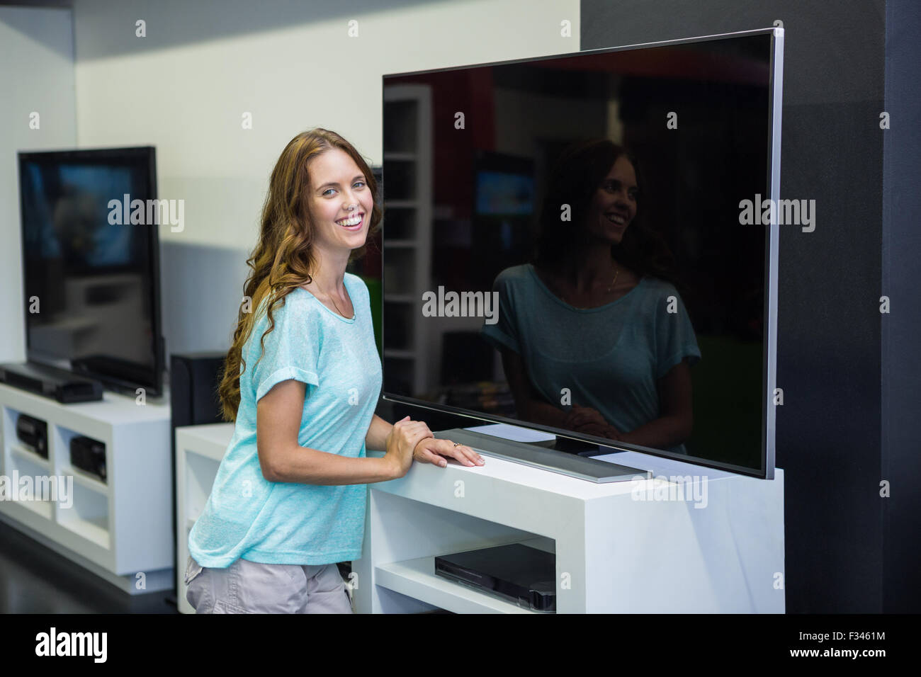 Pretty woman shopping for new television Stock Photo - Alamy