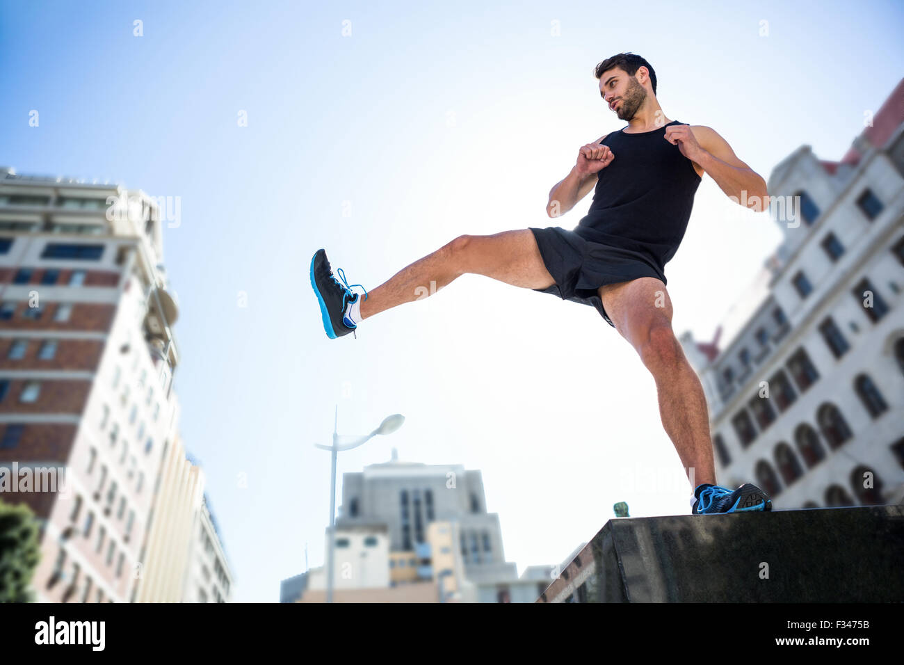 Handsome athlete kicking in the air Stock Photo - Alamy