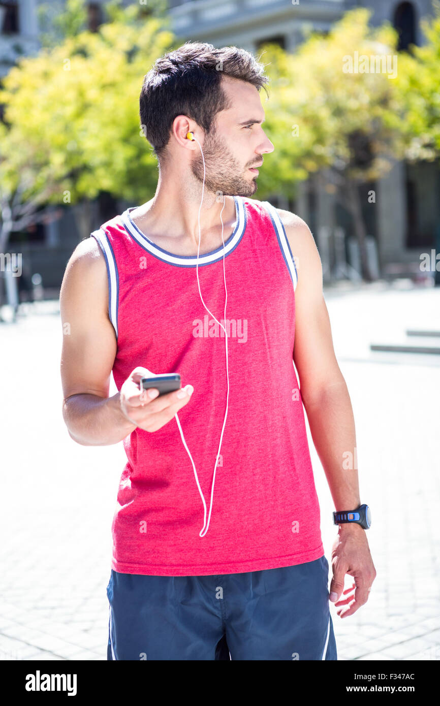 Handsome athlete sending a text Stock Photo - Alamy