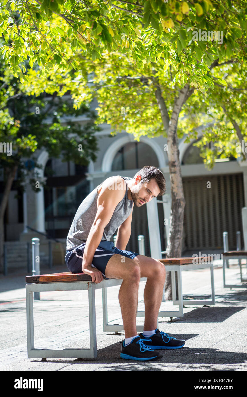 Exhausted athlete resting on a bench Stock Photo - Alamy