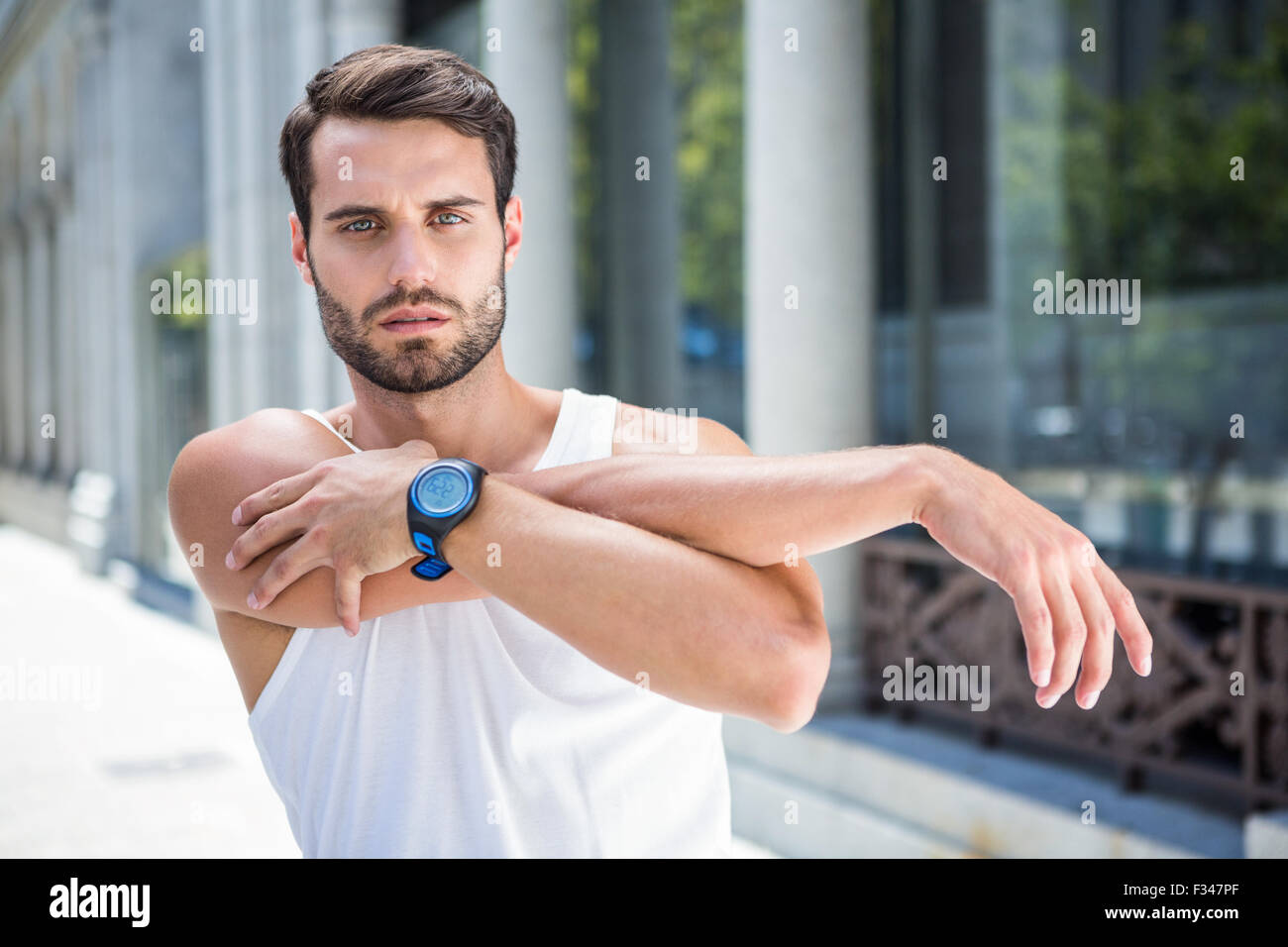 Focused handsome athlete stretching his arm Stock Photo - Alamy