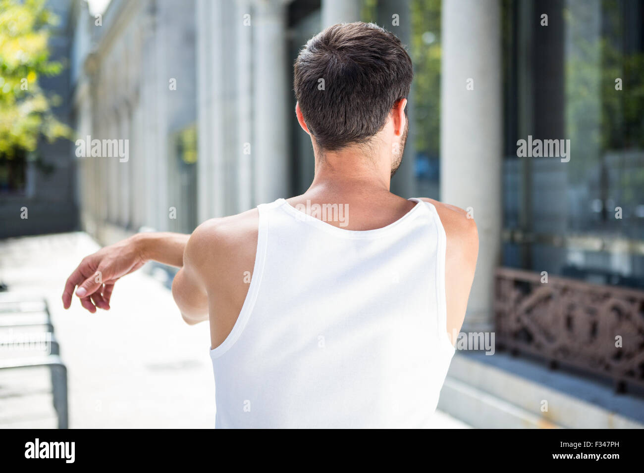 Rear view of athlete stretching his arm Stock Photo - Alamy