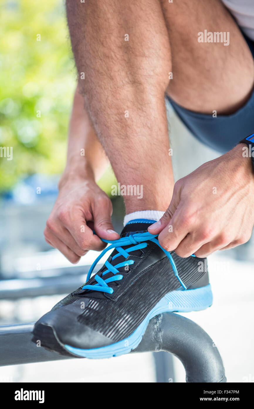 Athlete tying his shoes Stock Photo - Alamy