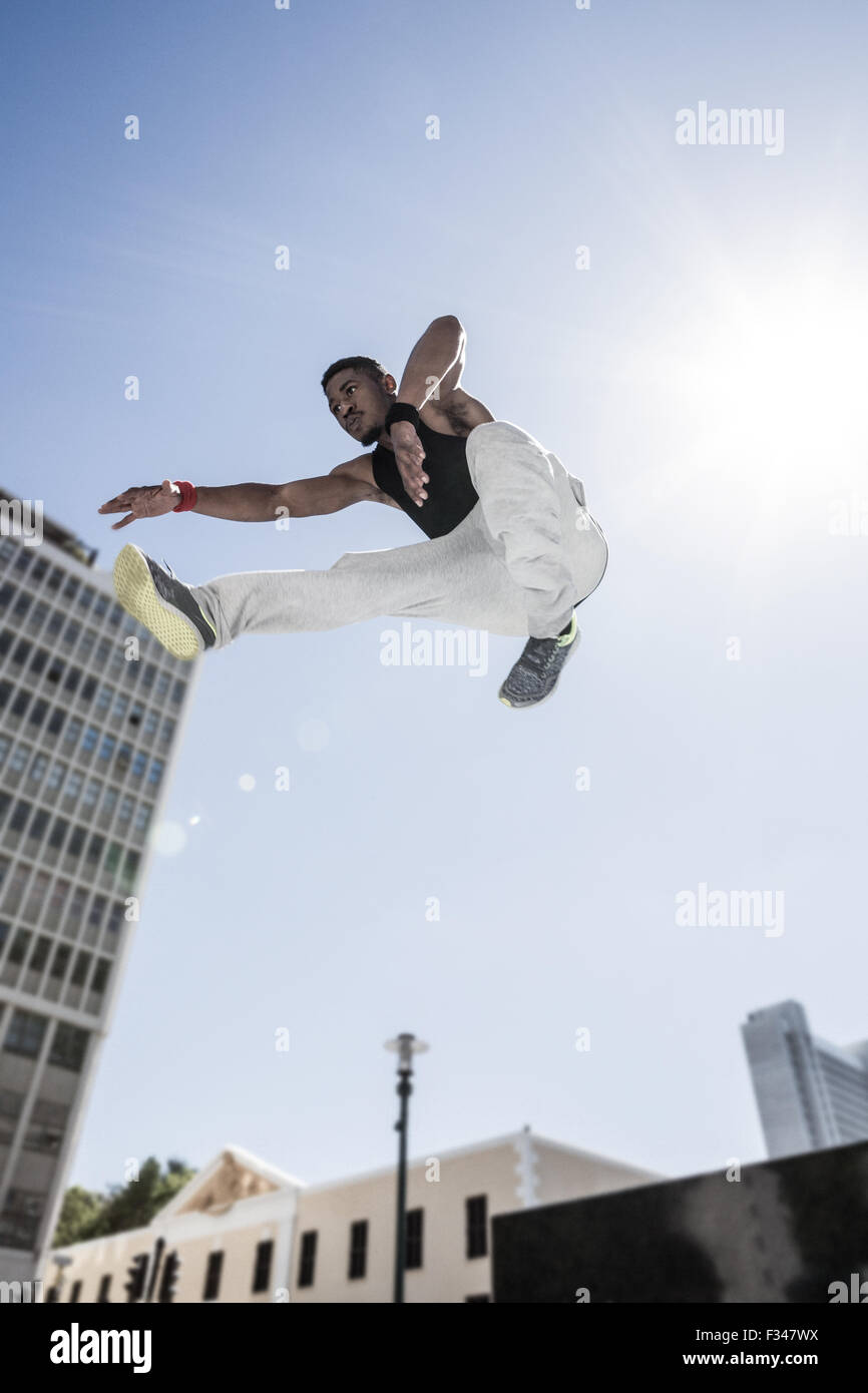 Extreme athlete jumping in front of building Stock Photo - Alamy