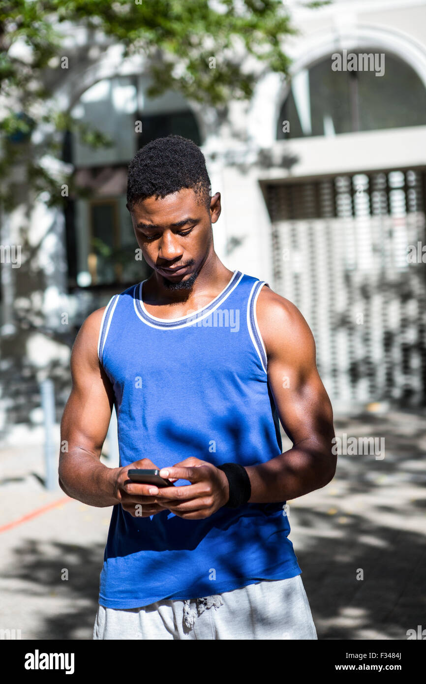 An handsome athlete using his phone Stock Photo - Alamy