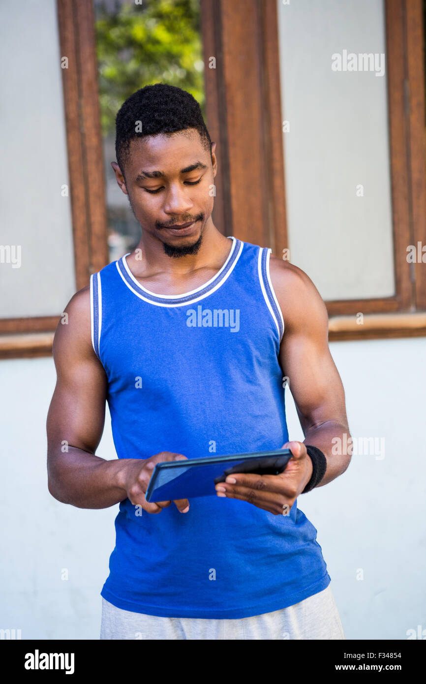 Smiling athletic man using tablet computer Stock Photo - Alamy Smiling athletic man using tablet computer Stock Photo - Alamy