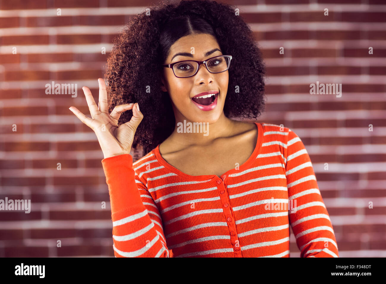 Attractive young woman showing OK sign Stock Photo - Alamy
