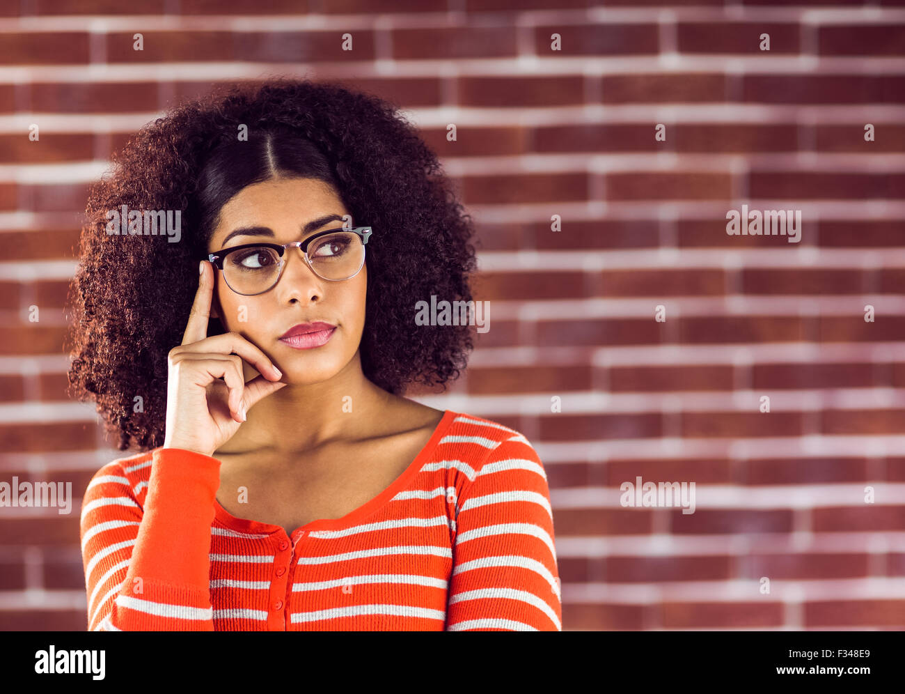 Attractive young woman thinking Stock Photo - Alamy