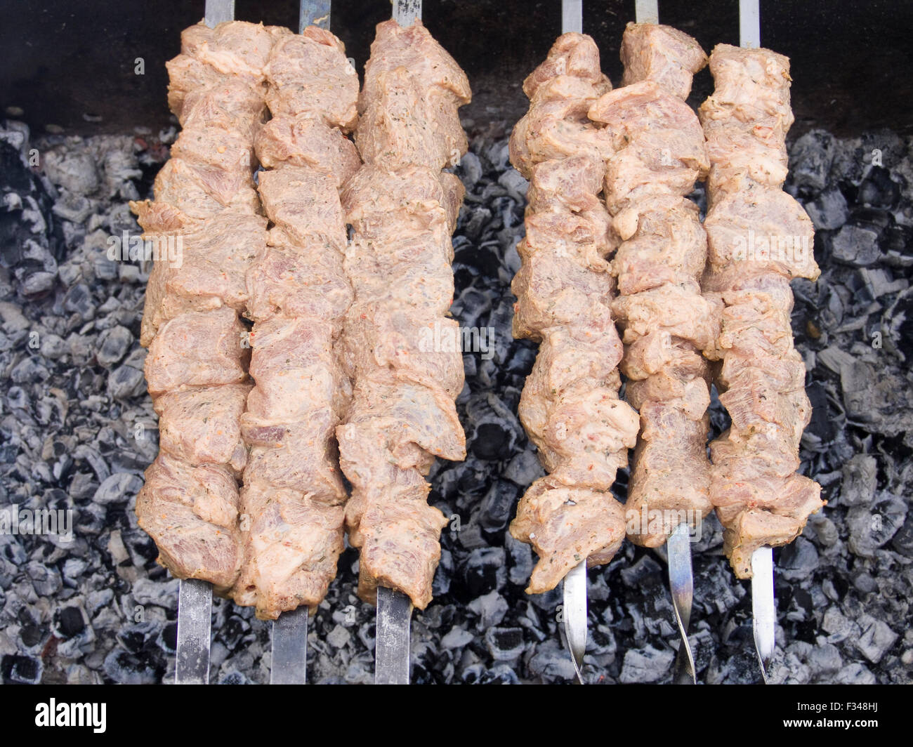 Process of preparation of a shish kebab, from uncooked to the cooked ...