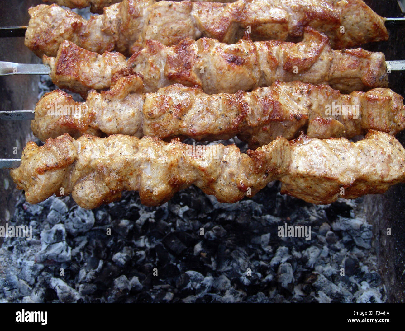 Process of preparation of a shish kebab, from uncooked to the cooked ...