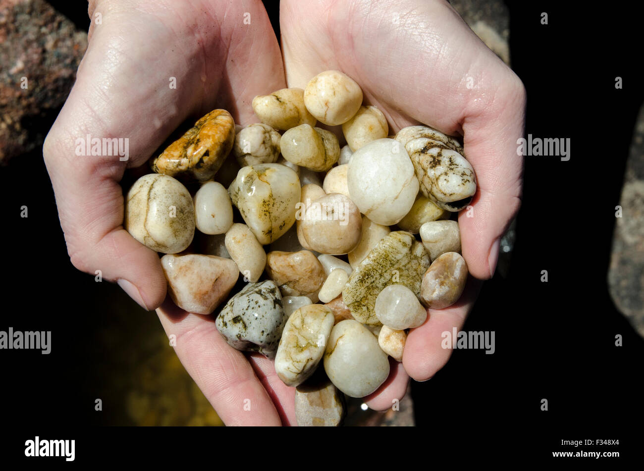 A handful of pebbles Stock Photo - Alamy