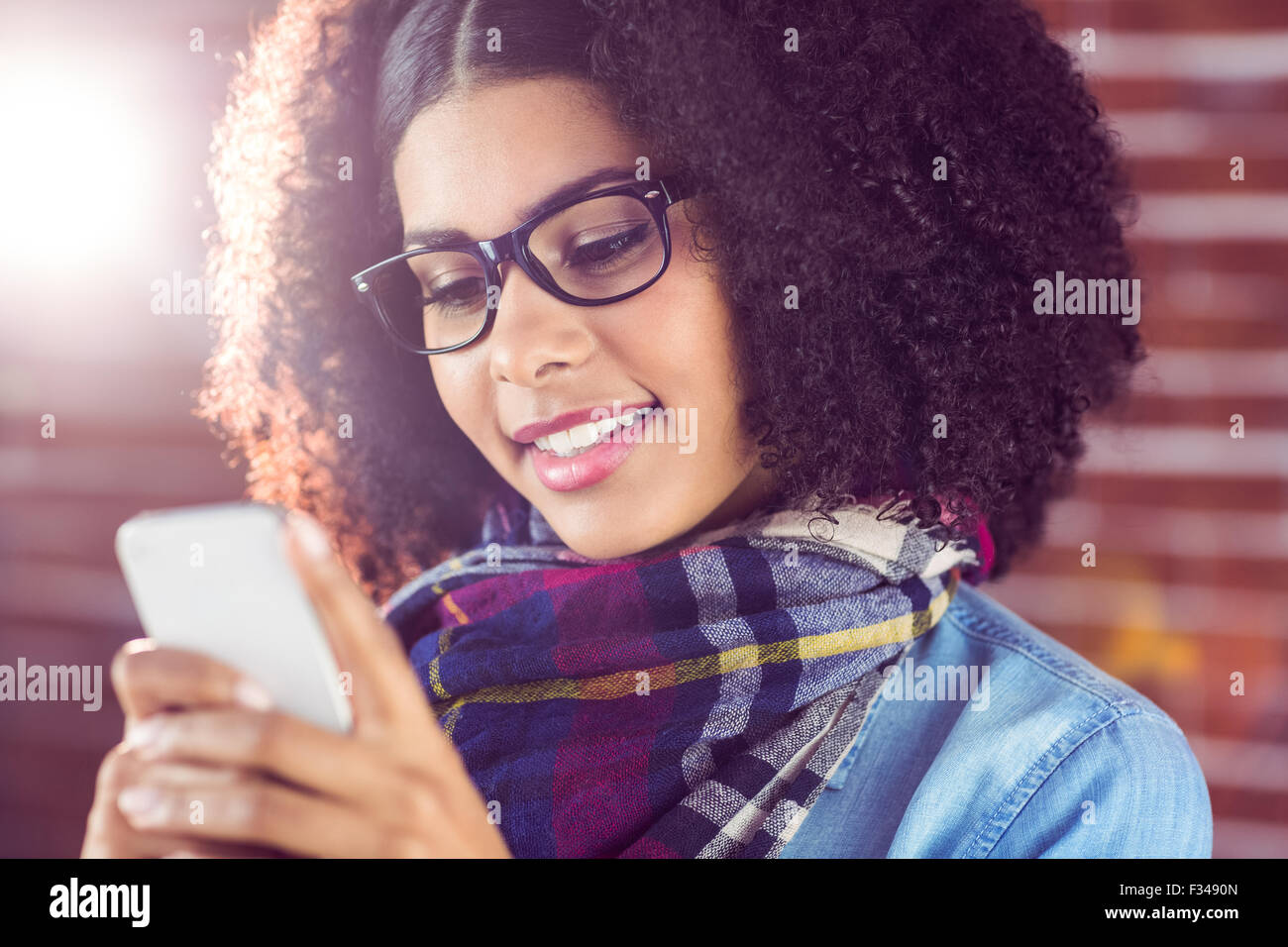 Smiling attractive hipster texting Stock Photo - Alamy