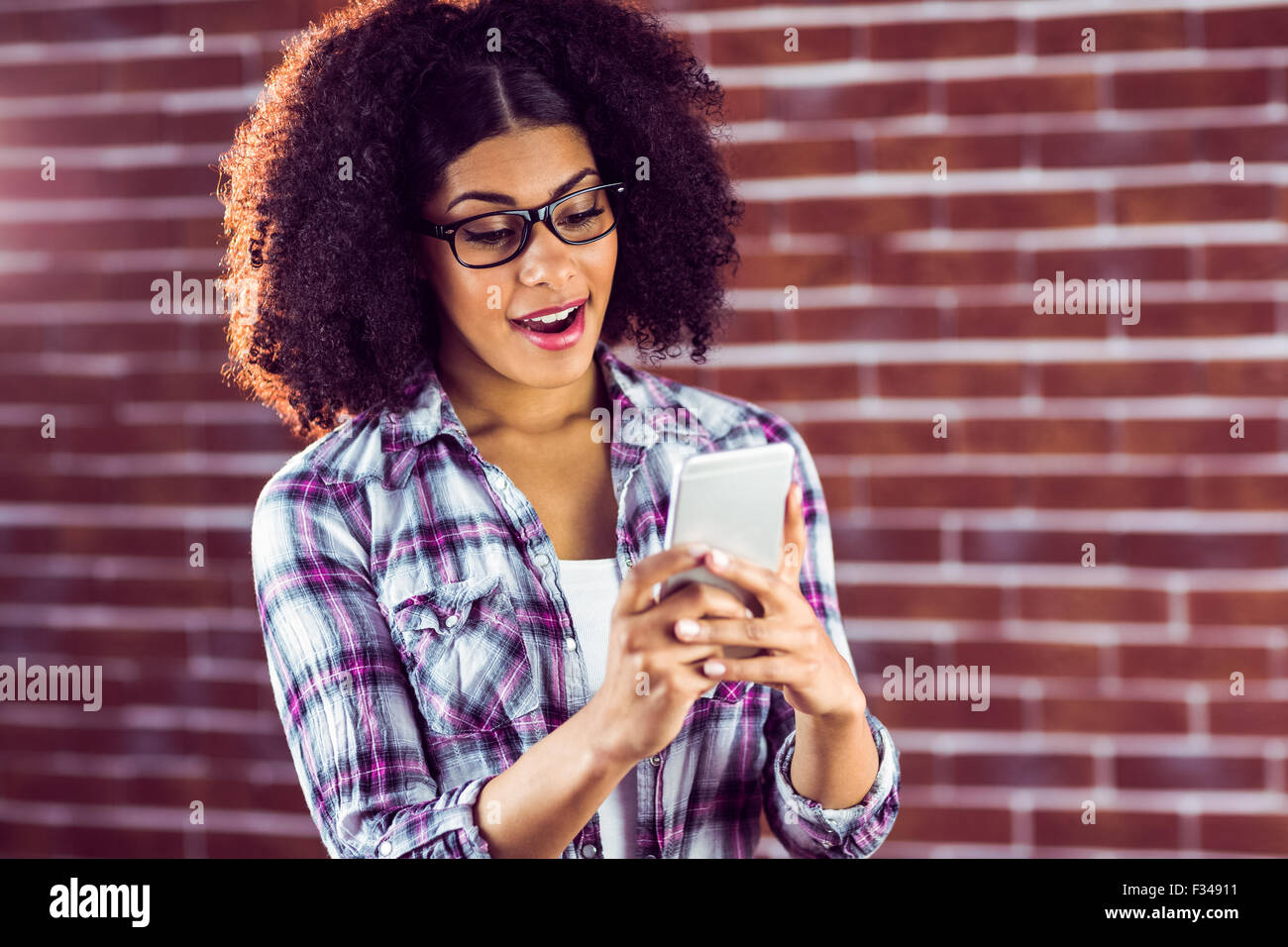 Surprised attractive hipster texting Stock Photo - Alamy