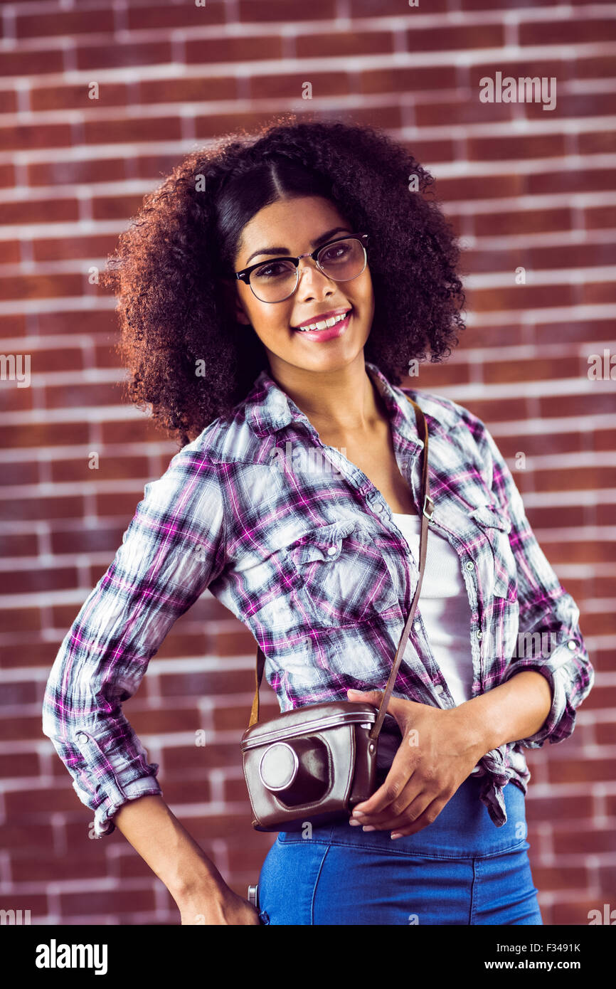 Attractive smiling hipster posing with camera Stock Photo - Alamy