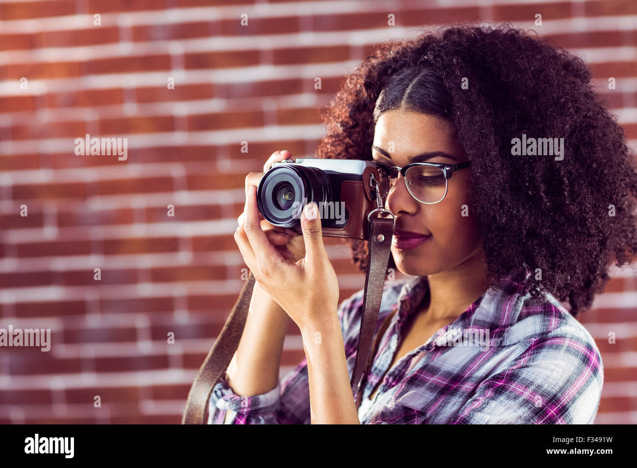 Attractive hipster photographing with camera Stock Photo - Alamy
